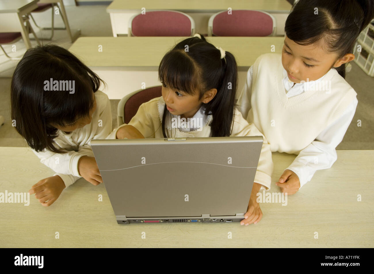 Girls using computer Stock Photo - Alamy