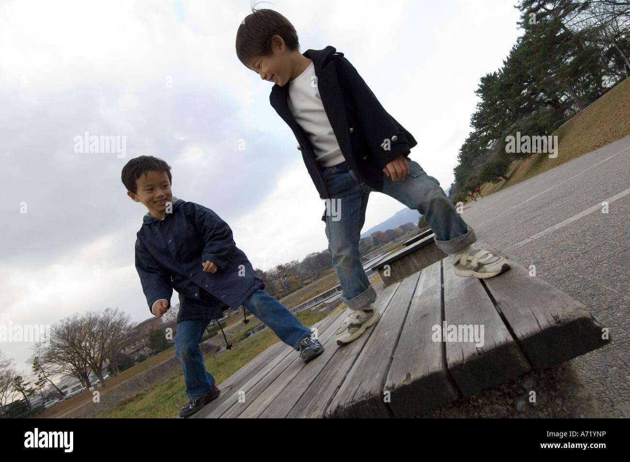 Boys playing in park Stock Photo - Alamy