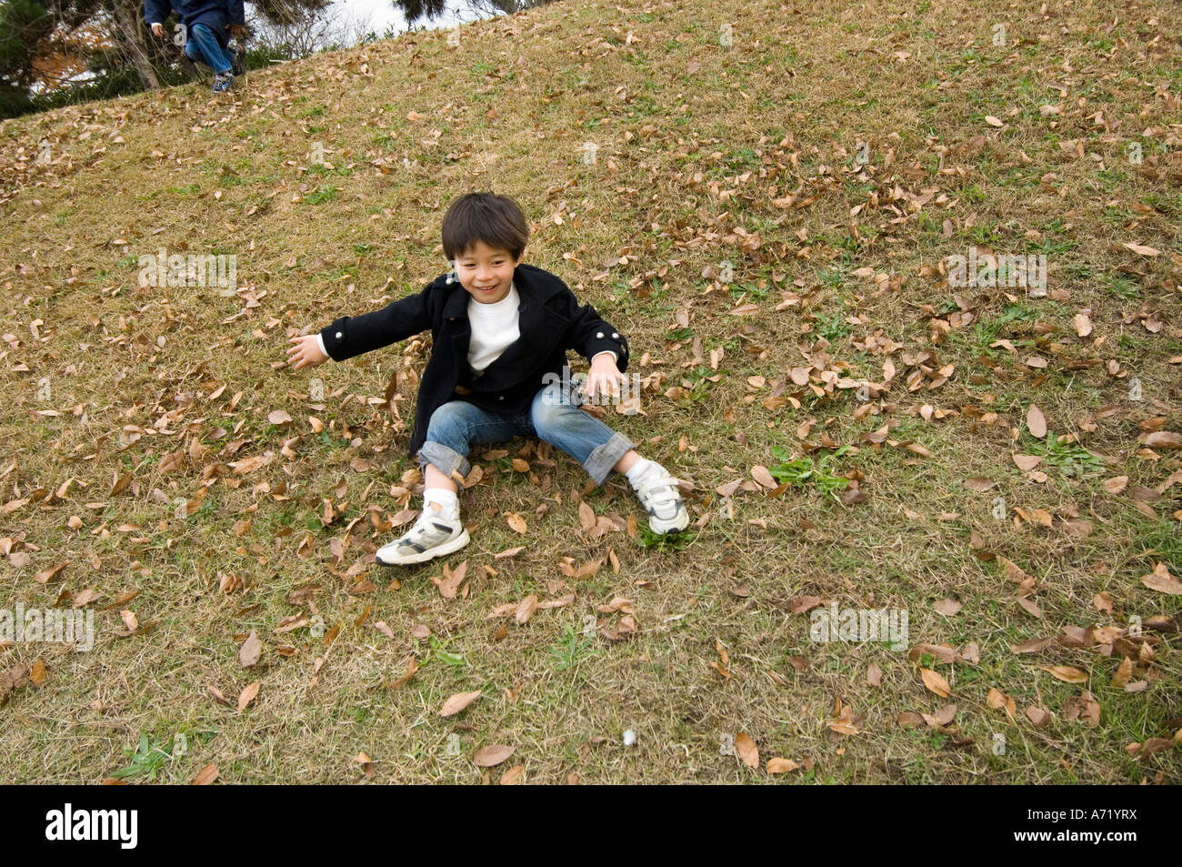 Boy playing in park Stock Photo - Alamy