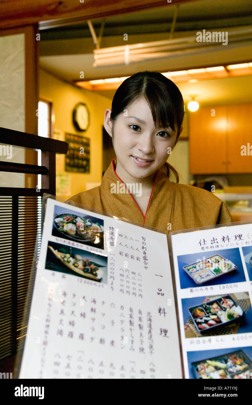 Waitress showing menu at Japanese restaurant Stock Photo - Alamy