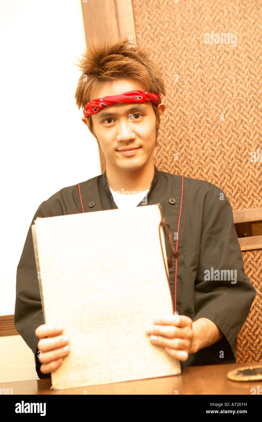 Young man holding menu Stock Photo - Alamy