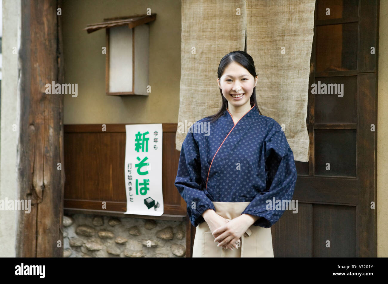 Young woman standing in front of restaurant Stock Photo - Alamy