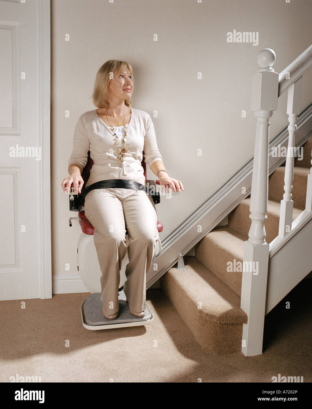 Elderly lady using stair lift hi-res stock photography and images - Alamy