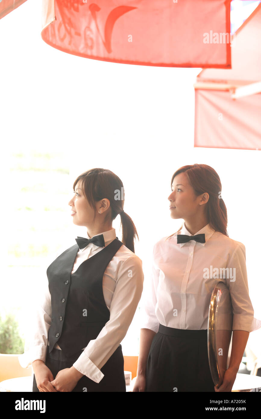 Two waitresses standing Stock Photo - Alamy