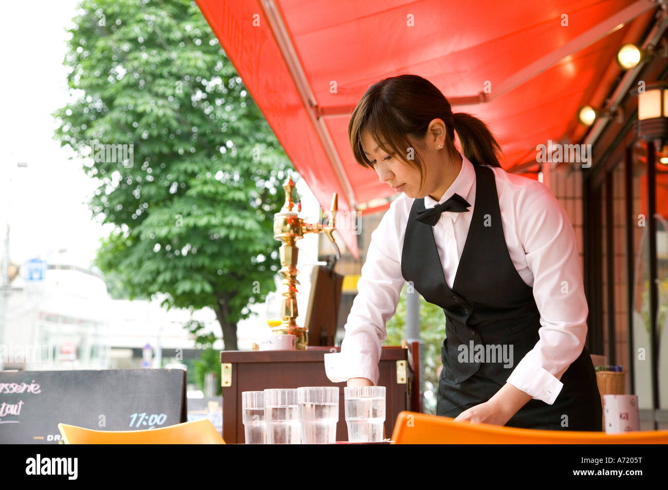 Waitress setting table Stock Photo - Alamy