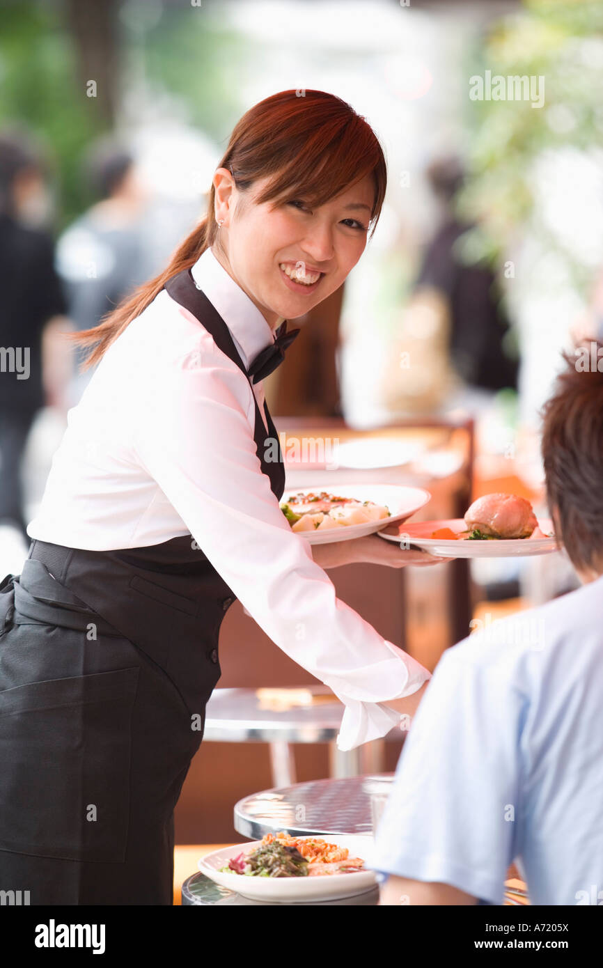 Waitress serving food Stock Photo - Alamy