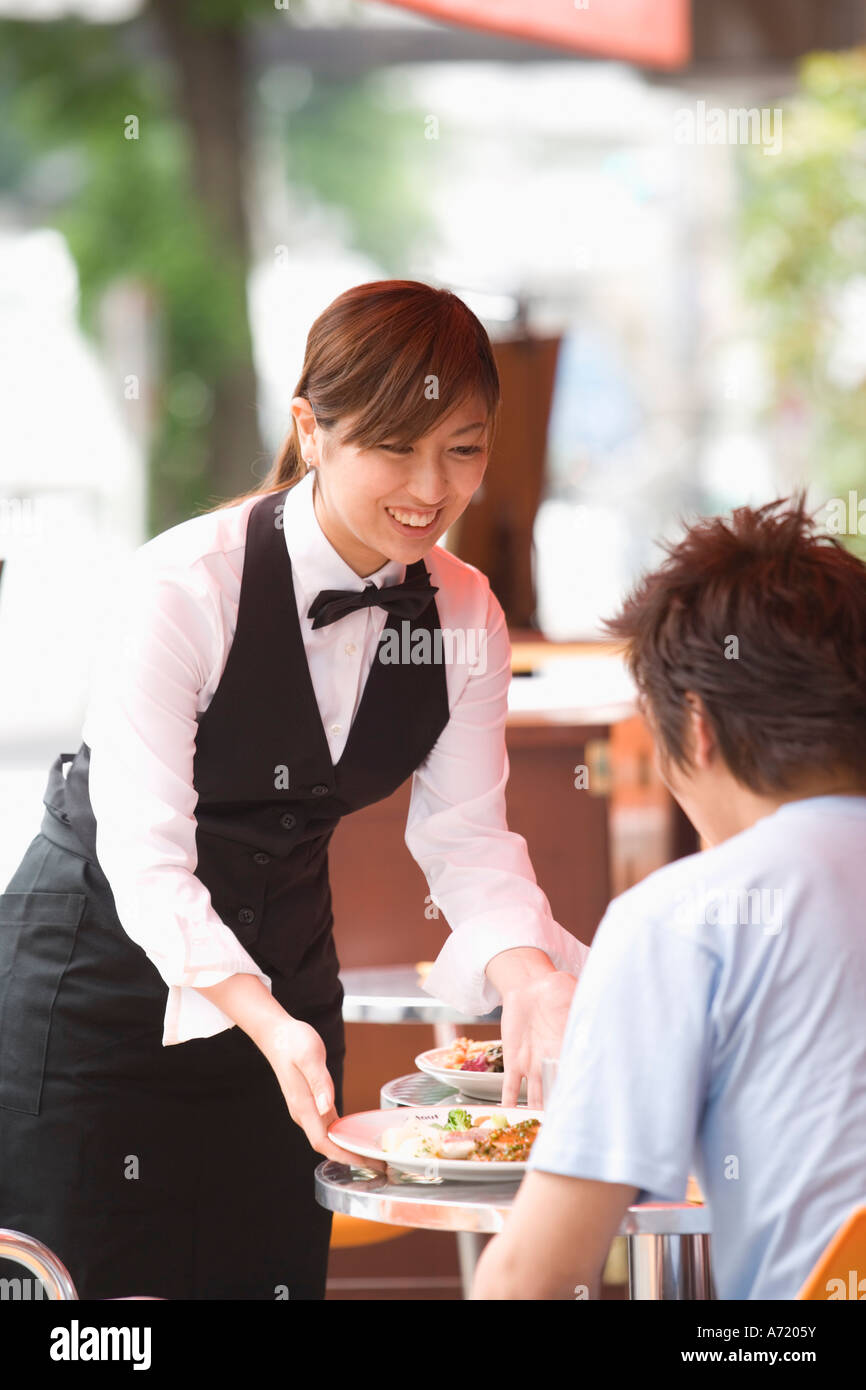 Waitress serving food Stock Photo - Alamy