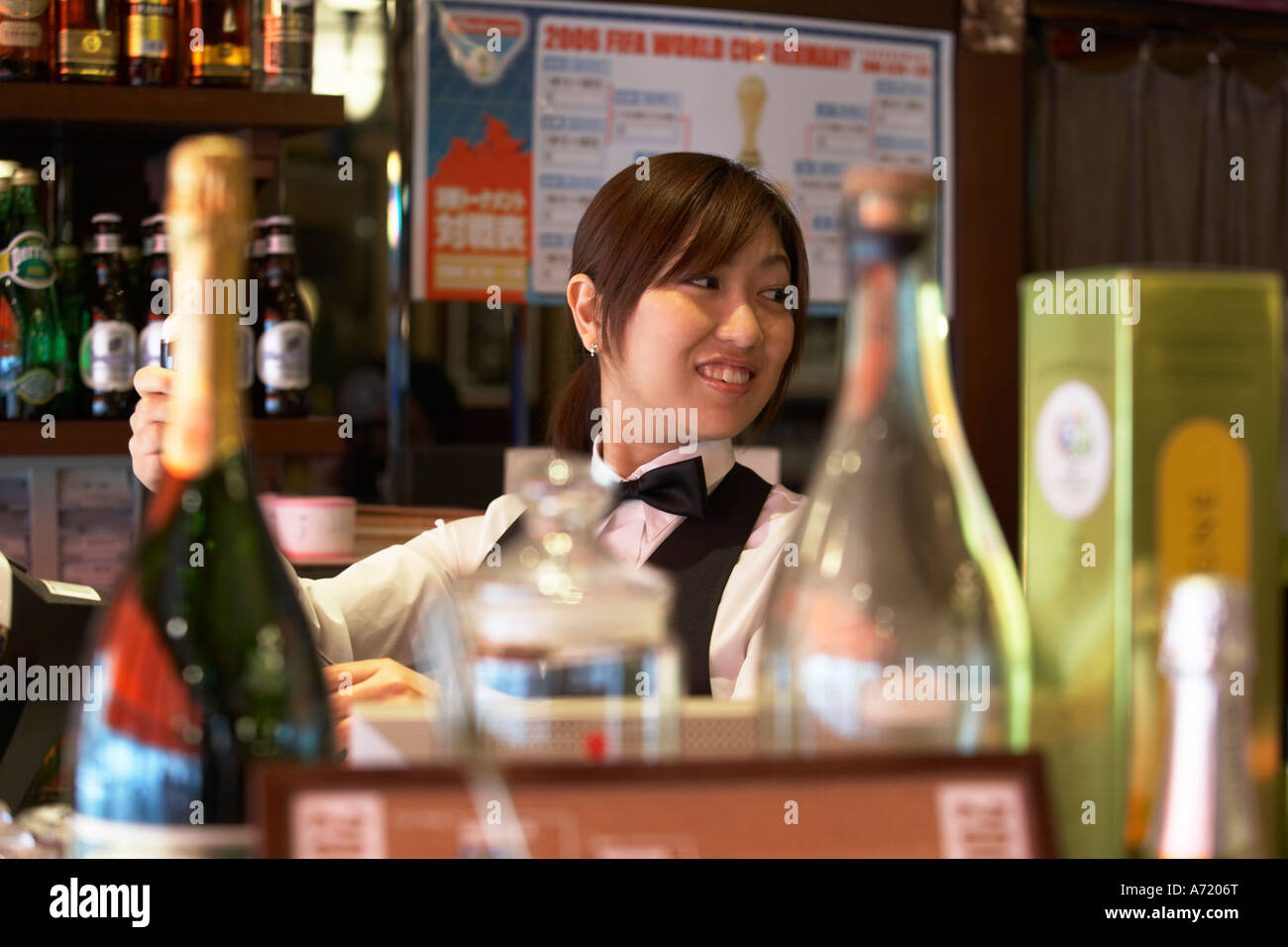 Waitress standing behind bar counter Stock Photo - Alamy