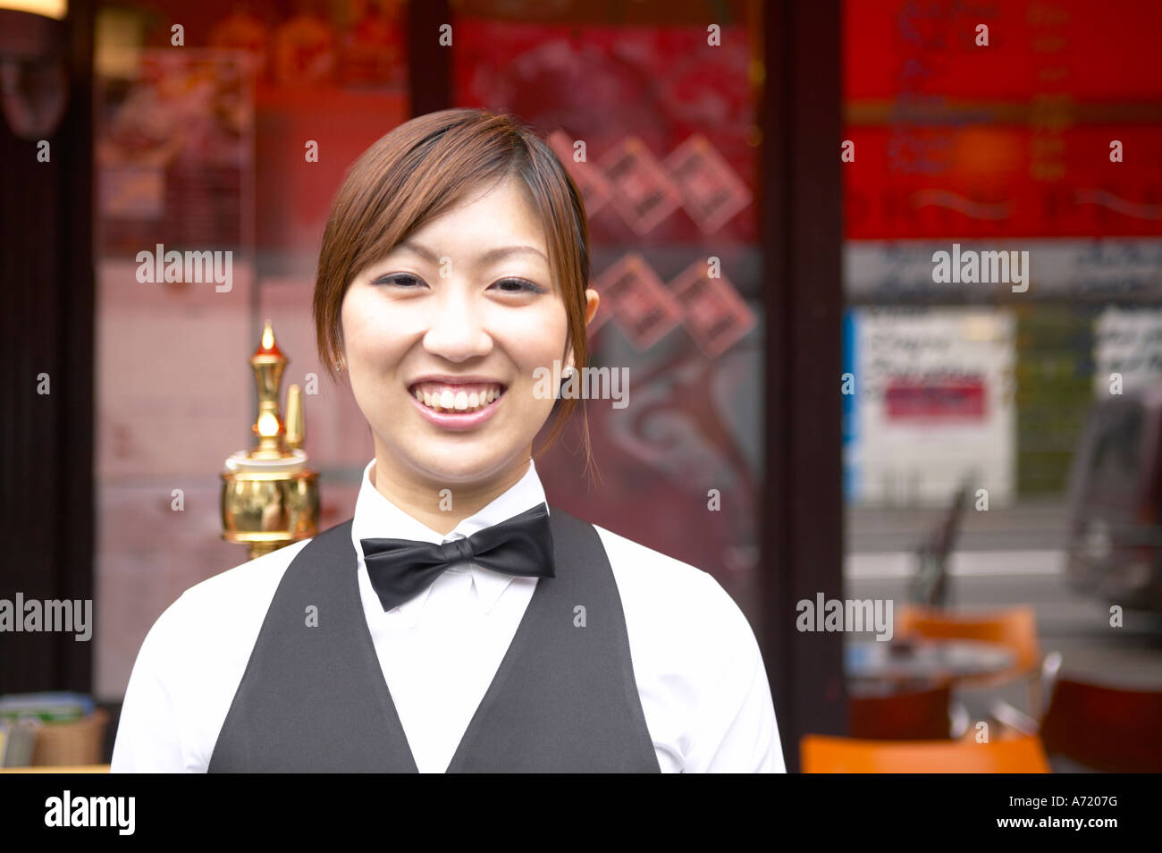 Waitress standing in front of coffee shop Stock Photo - Alamy