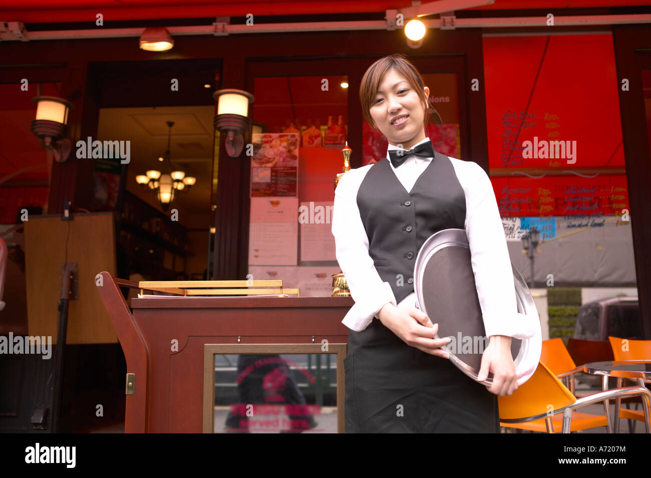 Waitress standing in front of coffee shop Stock Photo - Alamy