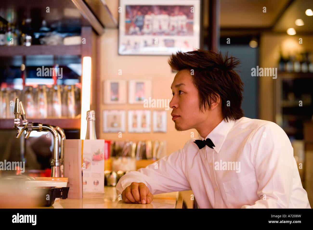 Waiter at bar counter Stock Photo - Alamy