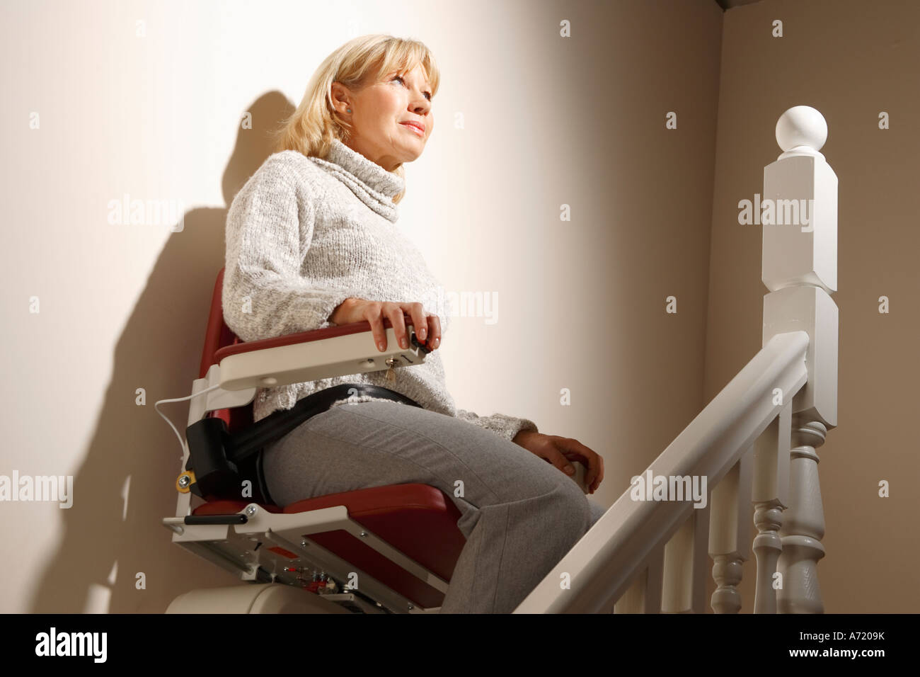 Elderly lady using stair lift hi-res stock photography and images - Alamy