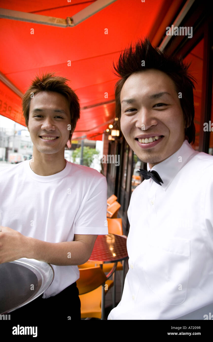 Two waiters standing in front of coffee shop Stock Photo - Alamy