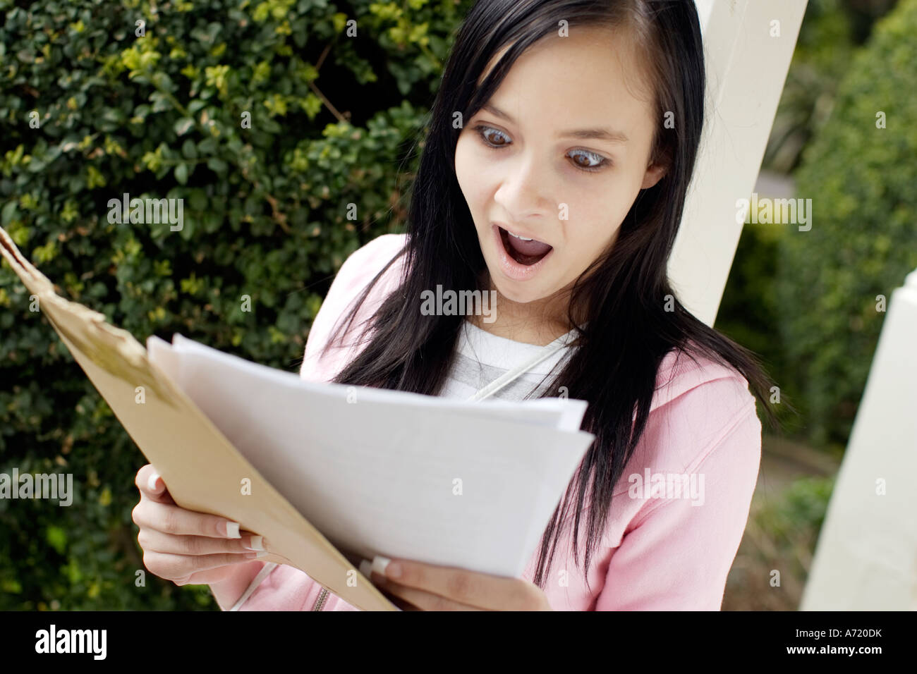 Girl pleased at receiving results Stock Photo - Alamy
