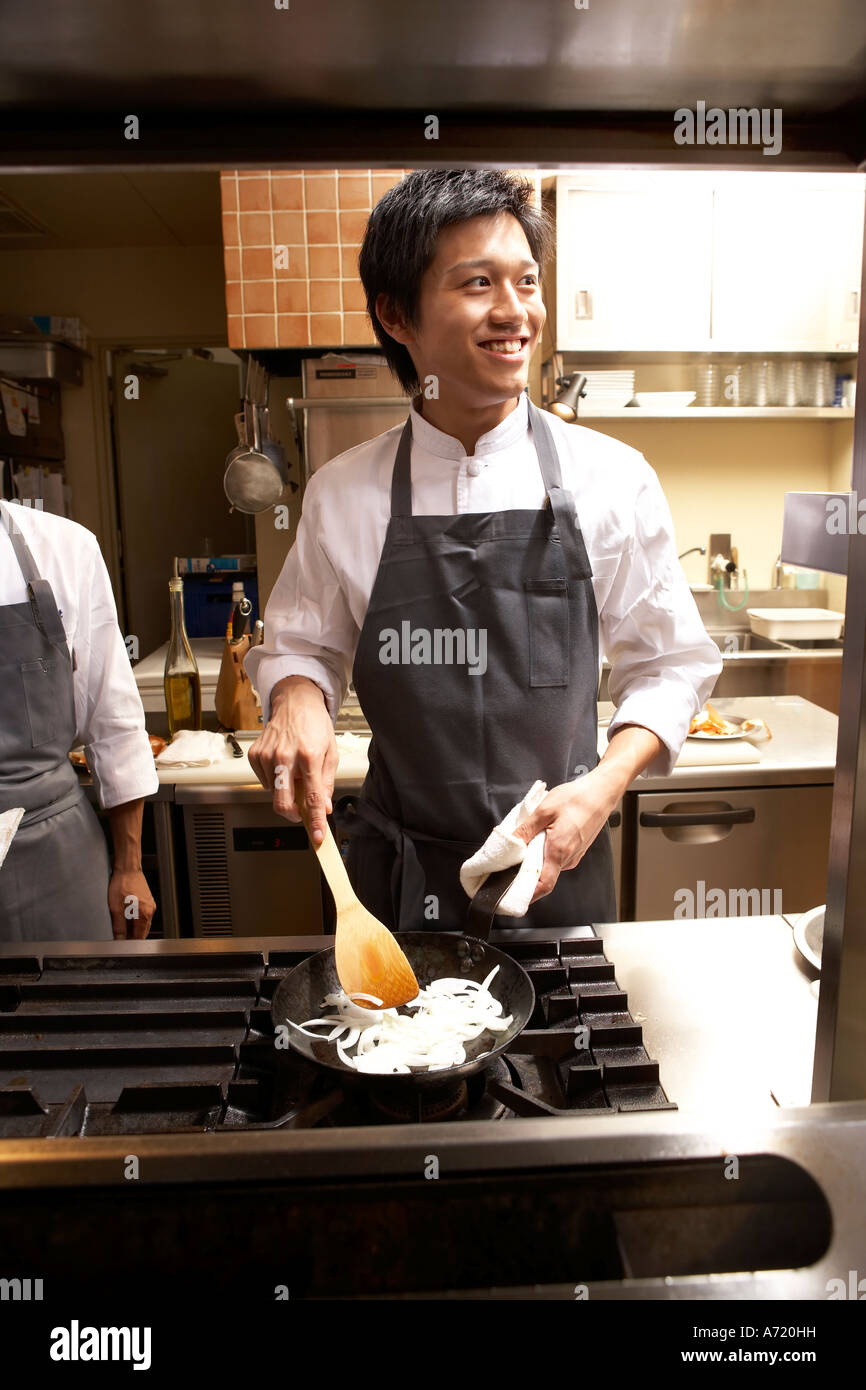 Chef cooking in restaurant kitchen Stock Photo - Alamy