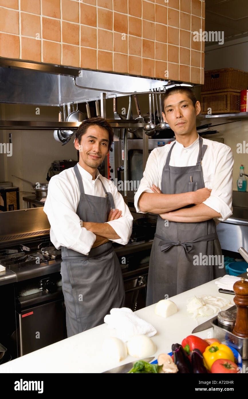 Two chefs standing in restaurant kitchen Stock Photo - Alamy
