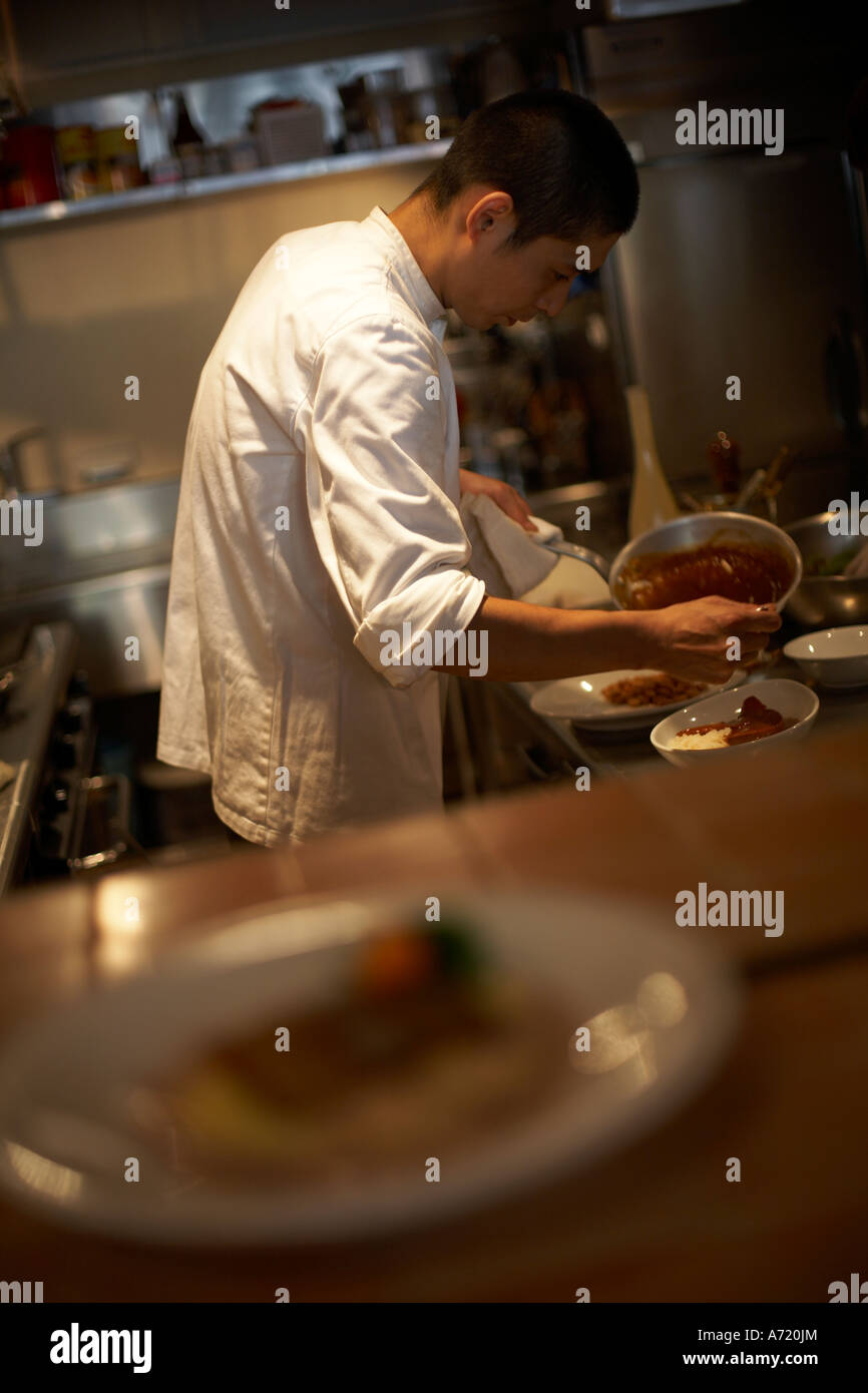 Chef cooking in restaurant kitchen Stock Photo - Alamy