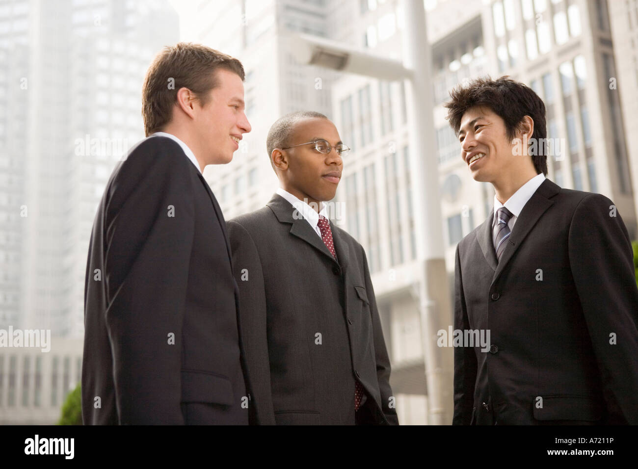 Three businessmen talking Stock Photo - Alamy