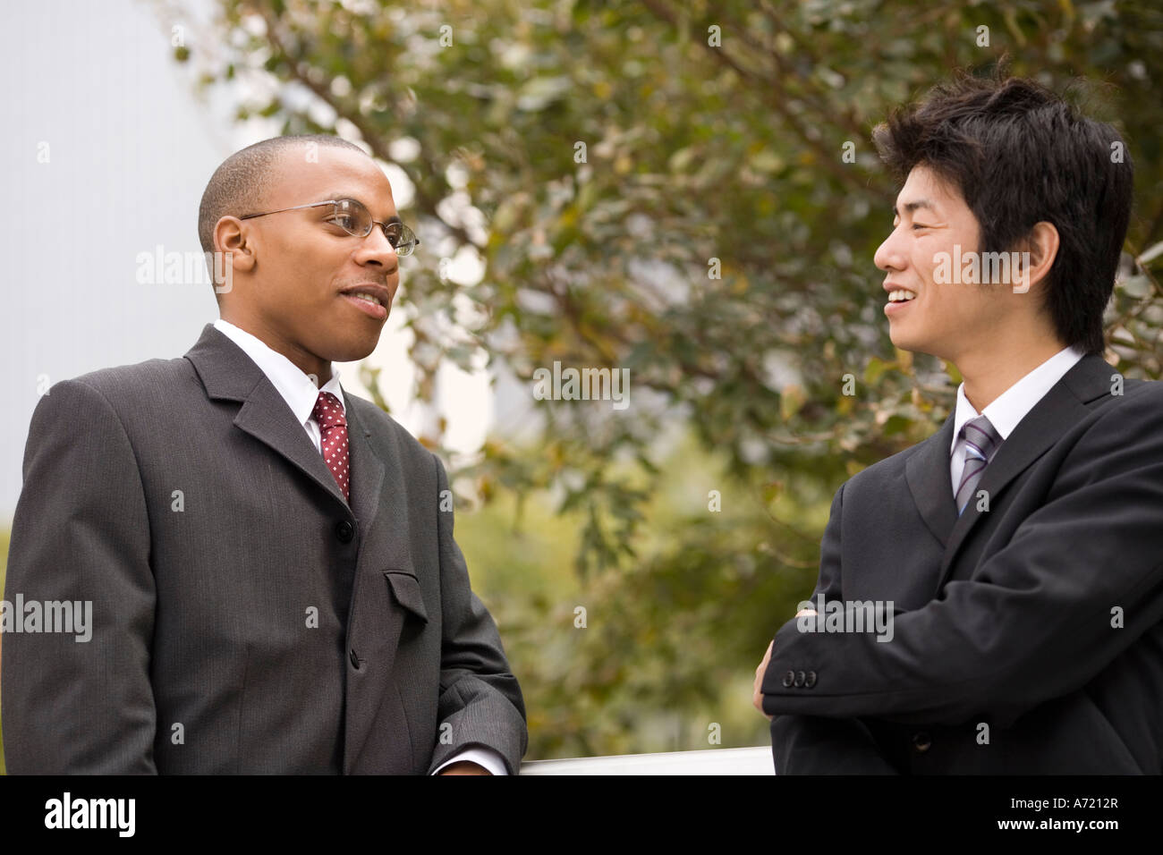 Two businessmen talking Stock Photo - Alamy