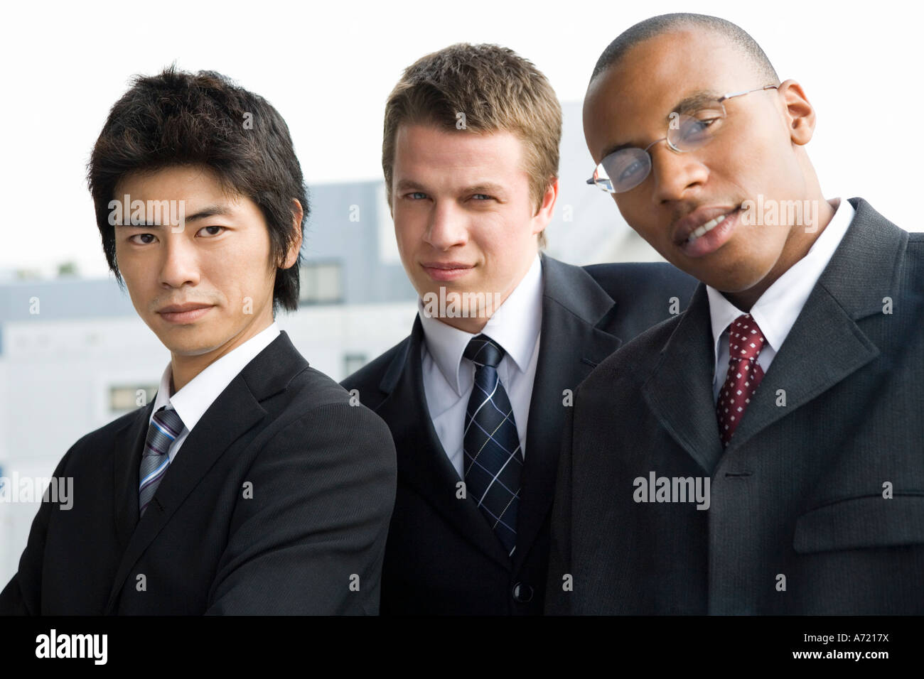 Three businessmen looking at camera Stock Photo - Alamy
