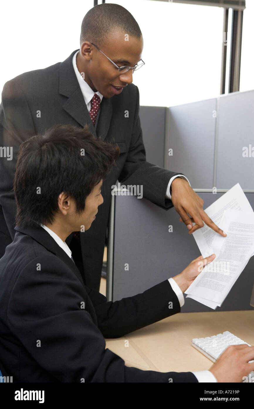 Two businessmen looking at documents Stock Photo - Alamy