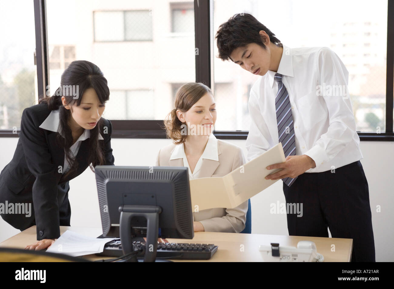 Three business people working in office Stock Photo - Alamy