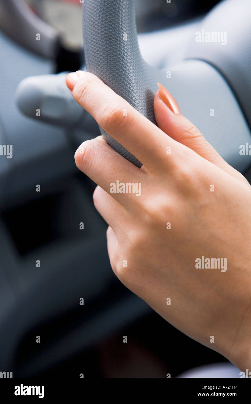 Close-up of woman's hand on wheel Stock Photo - Alamy