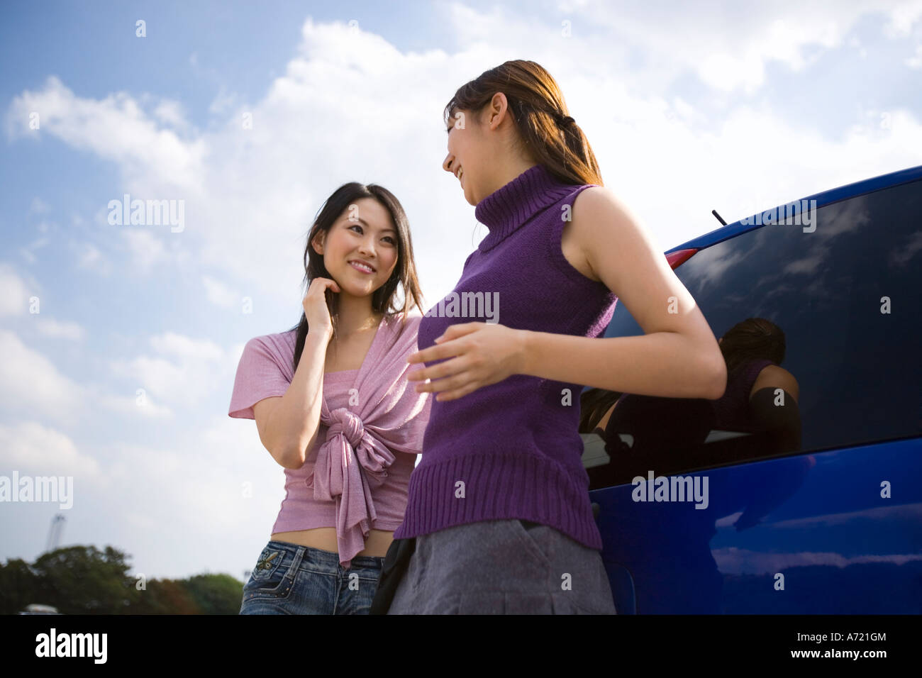 Two young women leaning against hi-res stock photography and images - Alamy