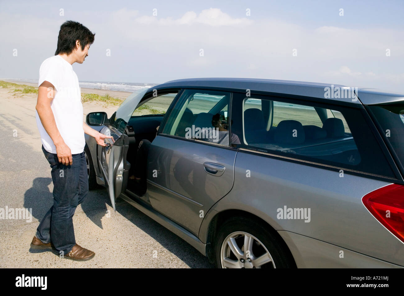 Young man opening car door Stock Photo - Alamy Young man opening car door Stock Photo - Alamy