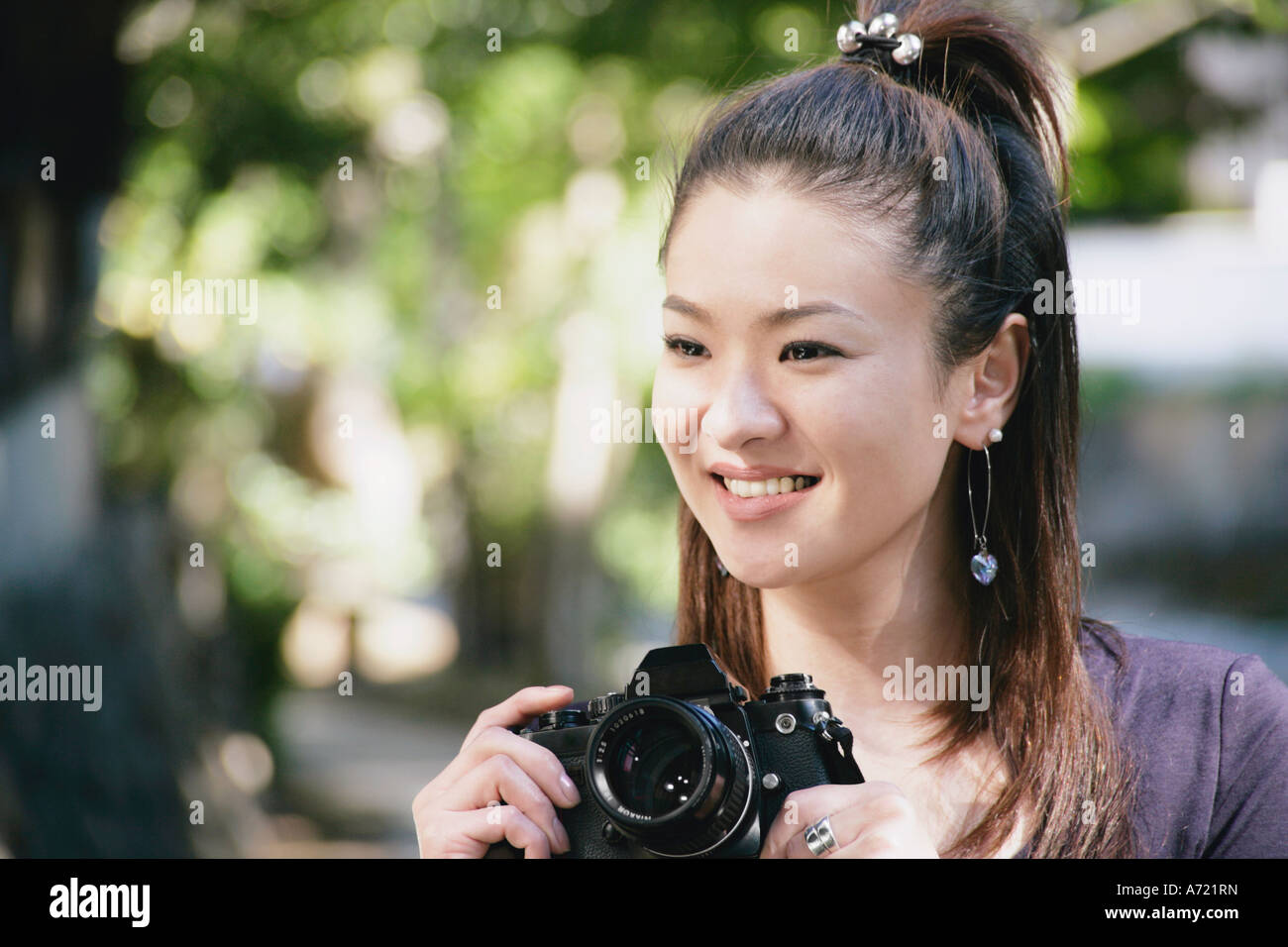 Young woman with camera Stock Photo - Alamy