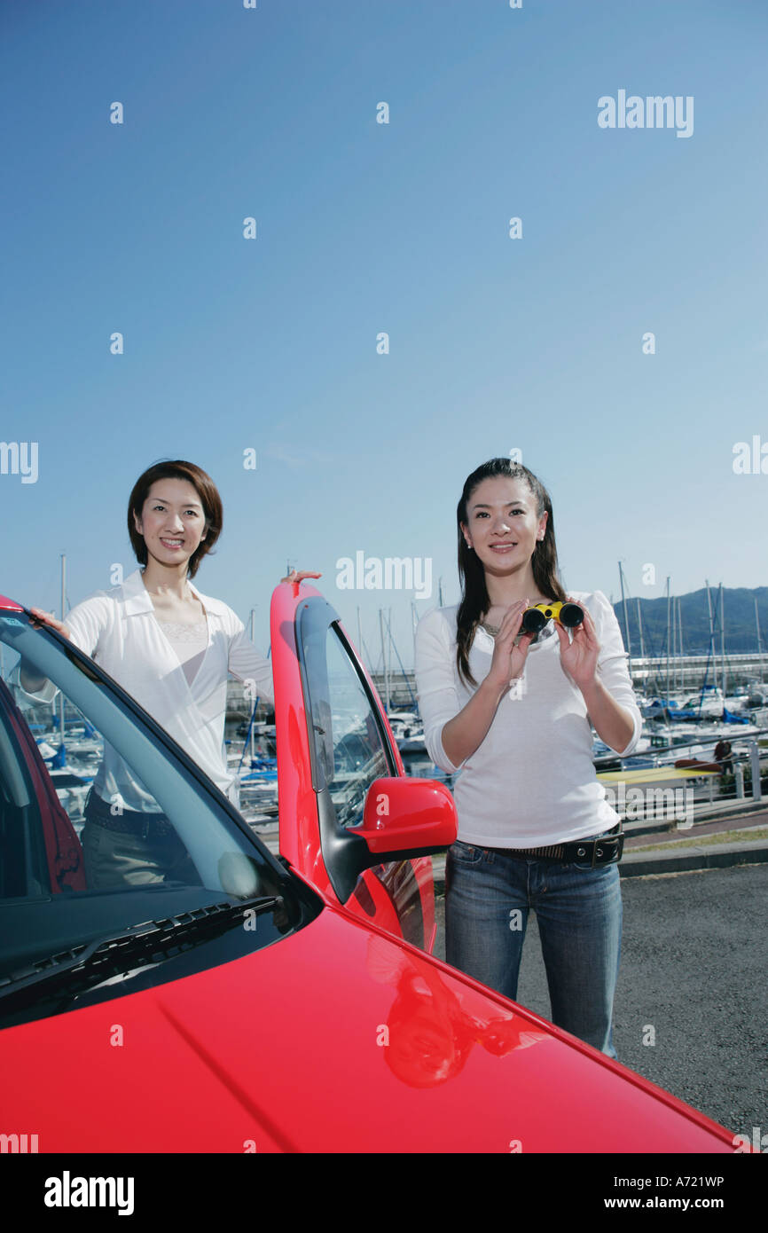 Two young women getting out of car by marina Stock Photo - Alamy