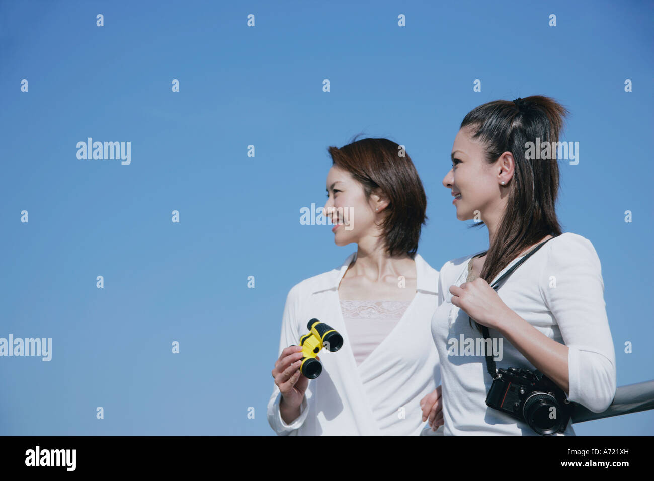 Two young women looking away Stock Photo - Alamy