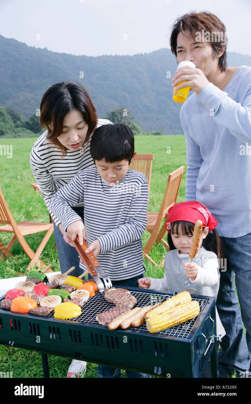 Family having barbeque Stock Photo - Alamy