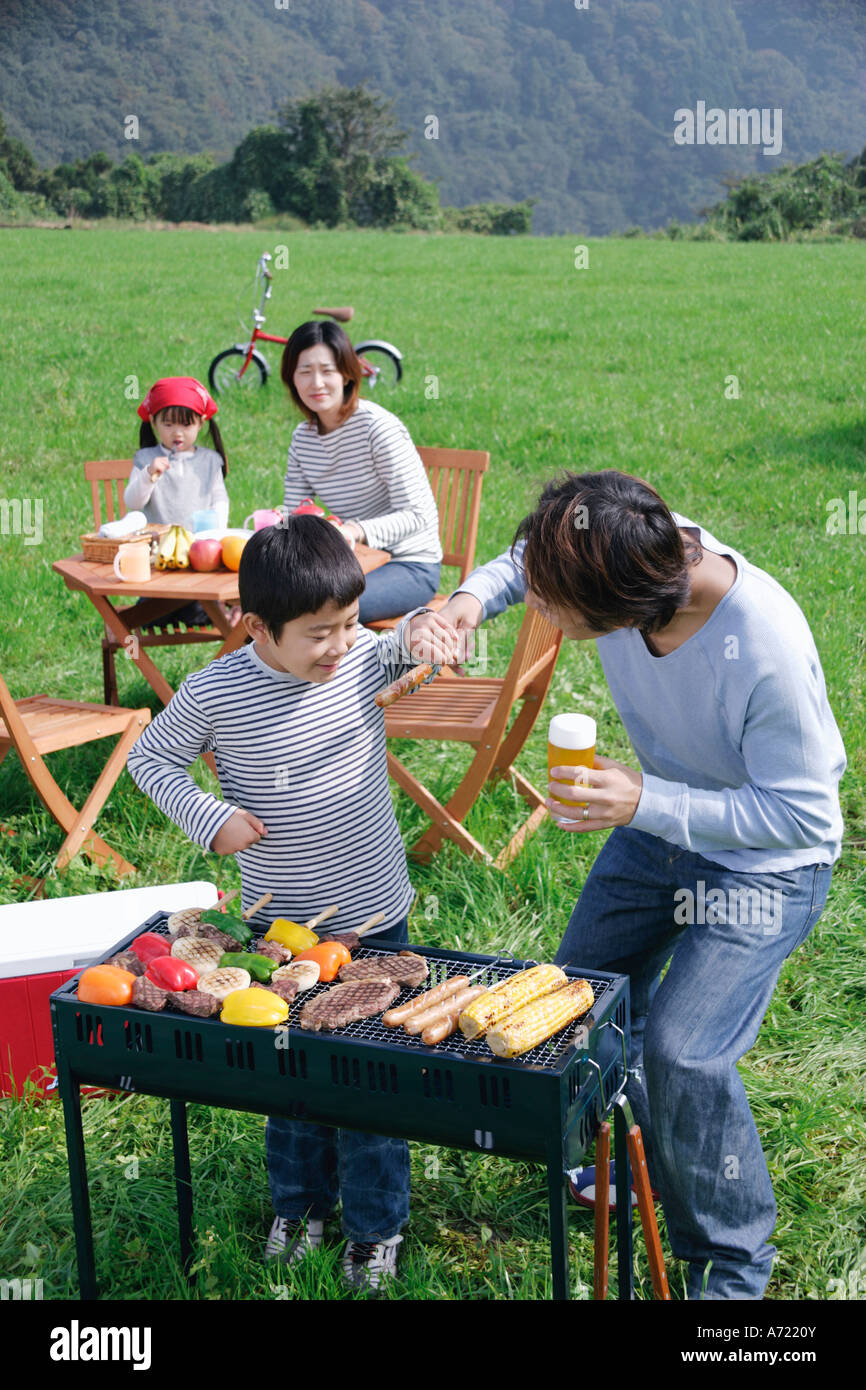 Family having barbeque Stock Photo - Alamy
