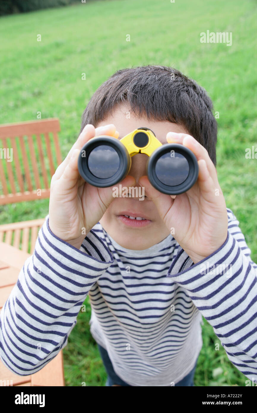 Boy using binoculars Stock Photo - Alamy