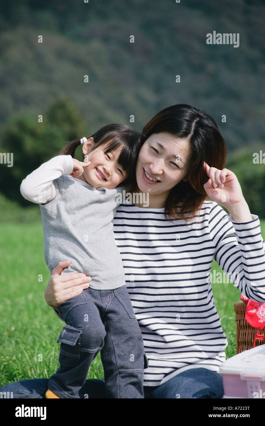 Mother and daughter looking at camera Stock Photo - Alamy