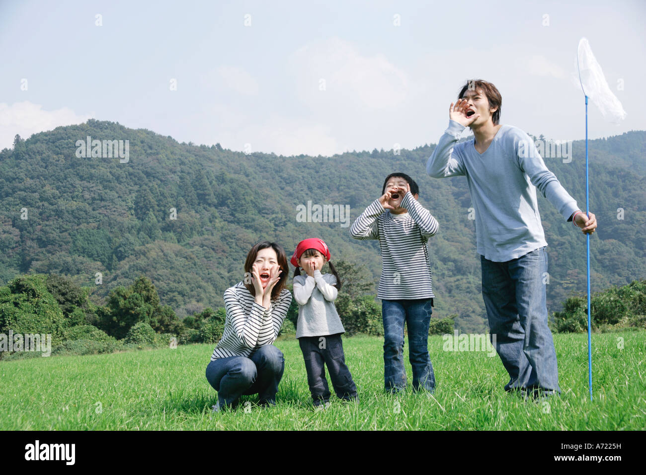 Family shouting in meadow Stock Photo - Alamy