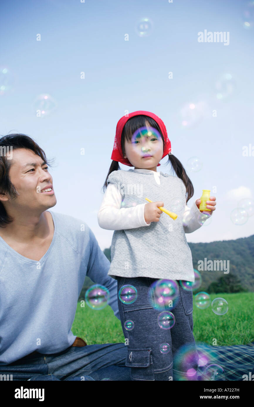 Blowing bubbles child father hi-res stock photography and images - Alamy