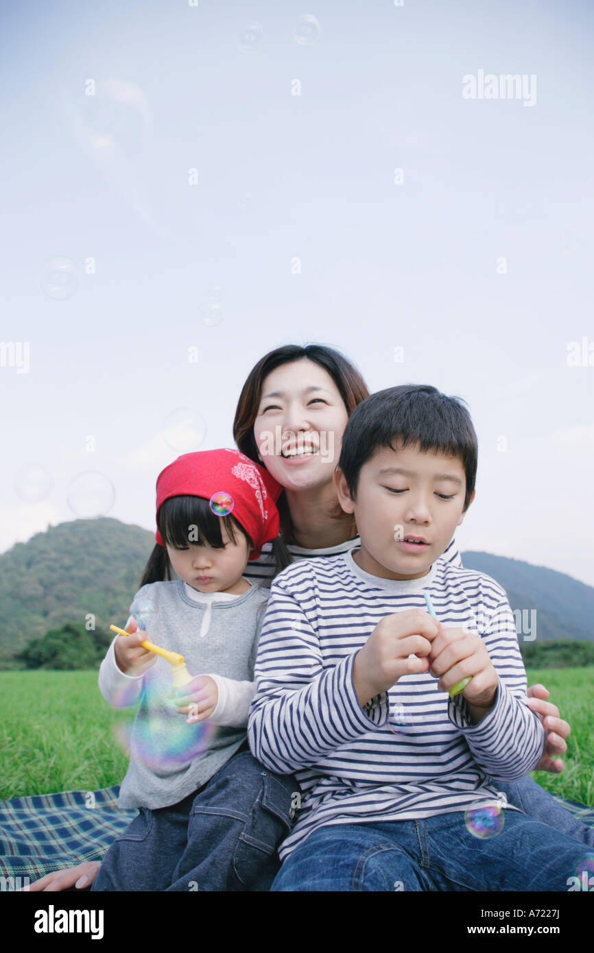 Family blowing bubbles Stock Photo - Alamy