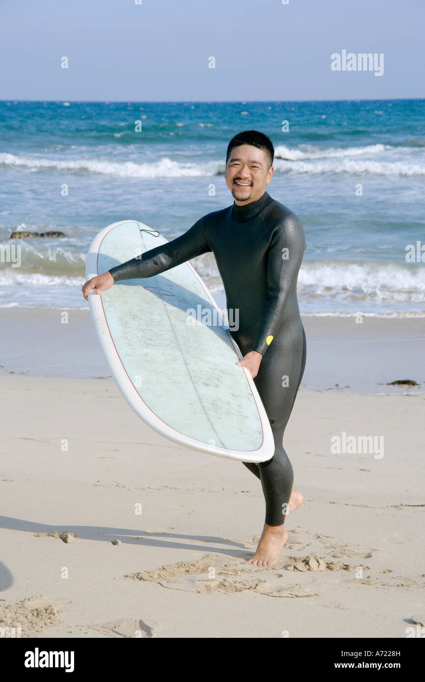 Man holding surfboard Stock Photo - Alamy