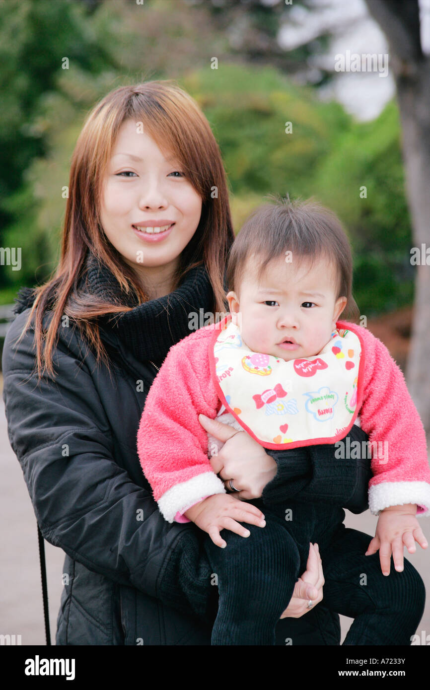 Mother carrying baby Stock Photo - Alamy