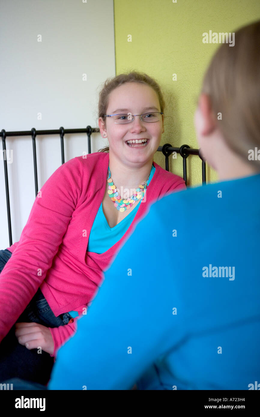 Two teenage girls talking in their room Stock Photo - Alamy