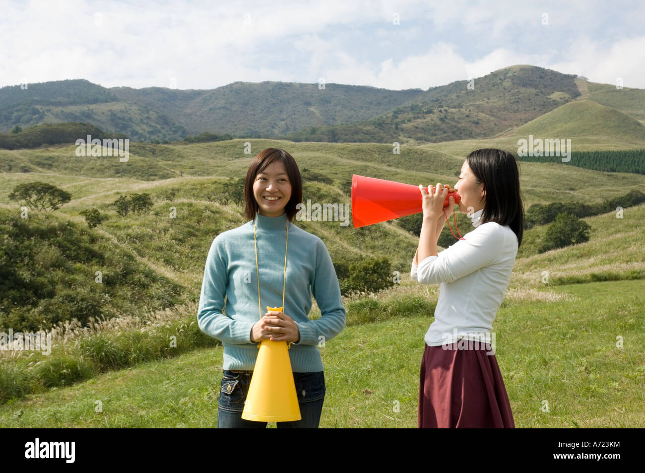 Two young women with megaphones Stock Photo - Alamy