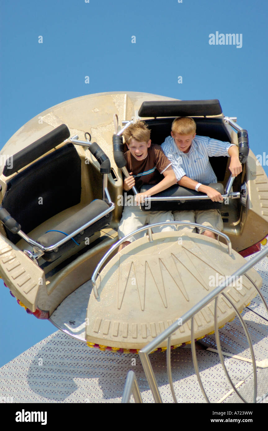 Teenage boys on carnival ride Stock Photo - Alamy