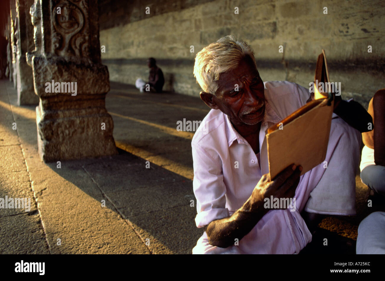 A man reads a religious book at the Sri Meenakshi Temple in Madurai ...