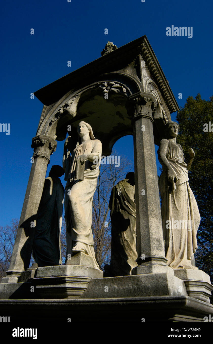 Carved stone sculptures statues over grave in cemetery Stock Photo - Alamy