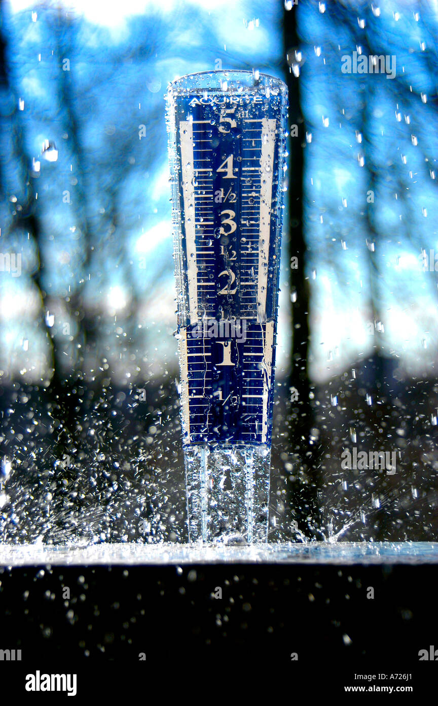 Stop action shot of rain falling around plastic rain guage Stock Photo ...