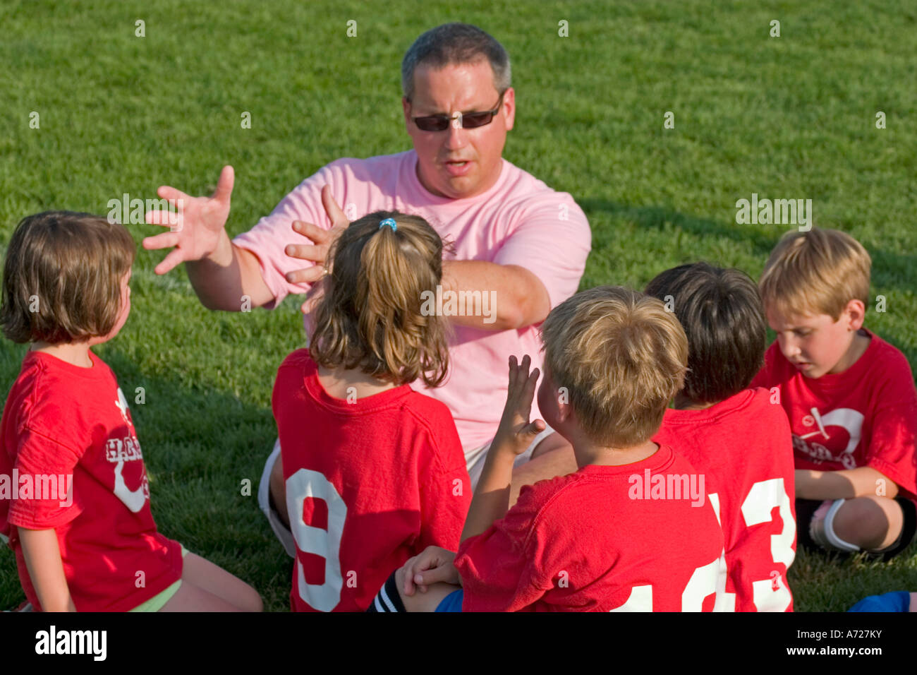 Intense soccer coach advising players age 42 and 6. Carondelet Field by ...