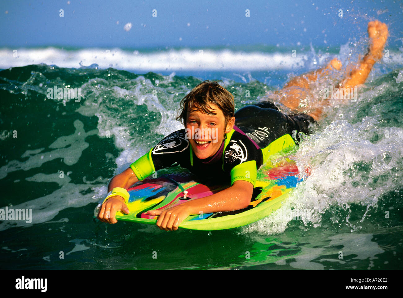 Child riding wave hi-res stock photography and images - Alamy