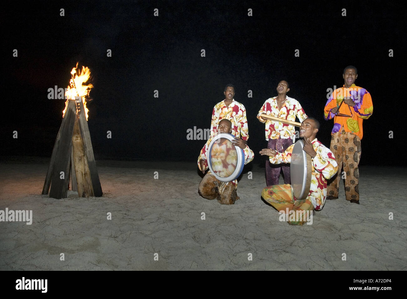african musicians playing percussion on a beach at night Stock Photo ...